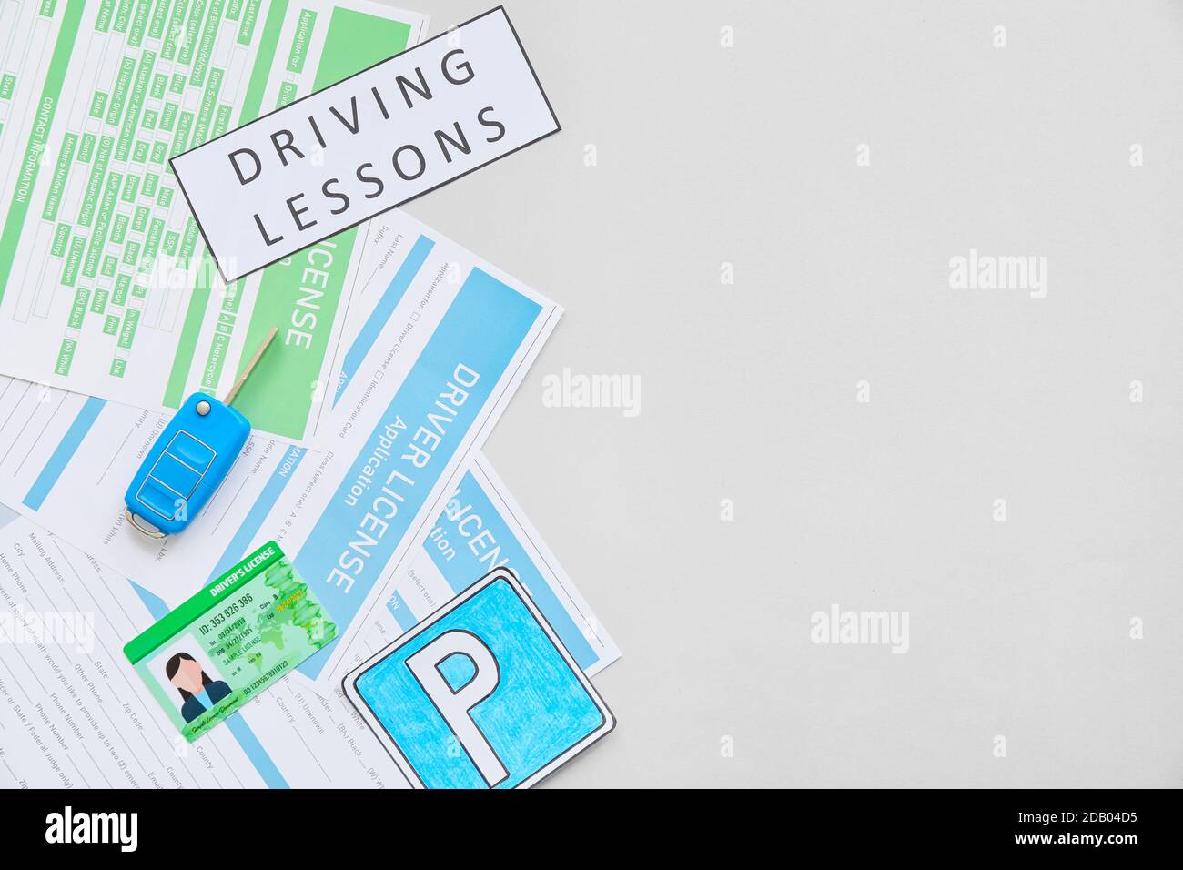 Driving license with application forms and car key on white background ...