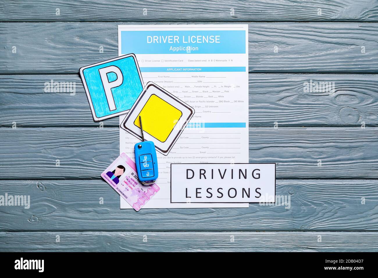 Driving license with application form, car key and traffic signs on ...