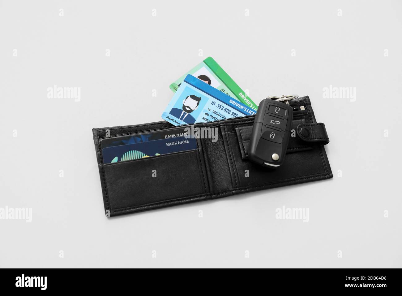 Wallet with driving licenses and car key on white background Stock ...