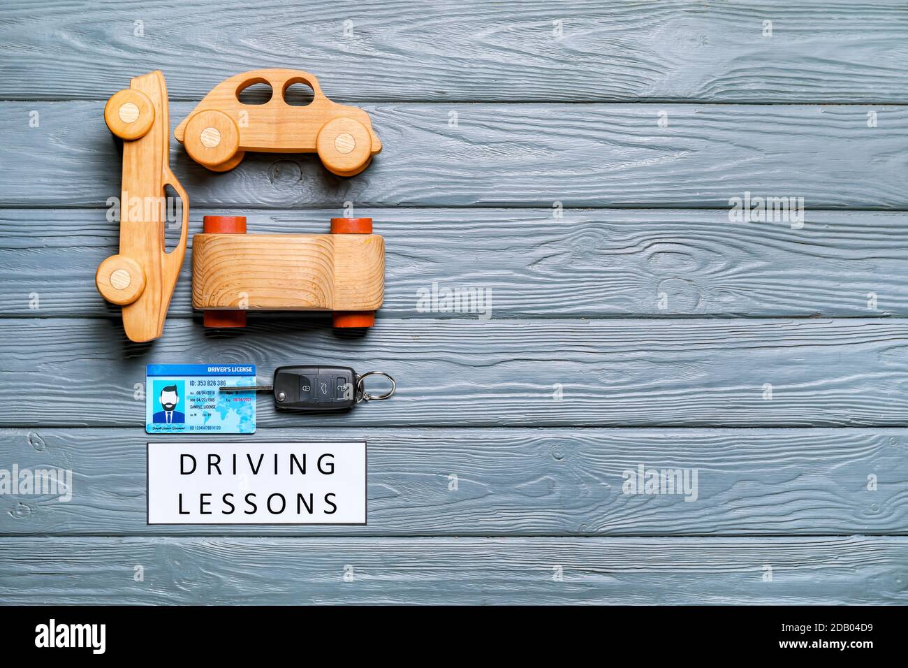 Driving license with key and cars on wooden background Stock Photo - Alamy