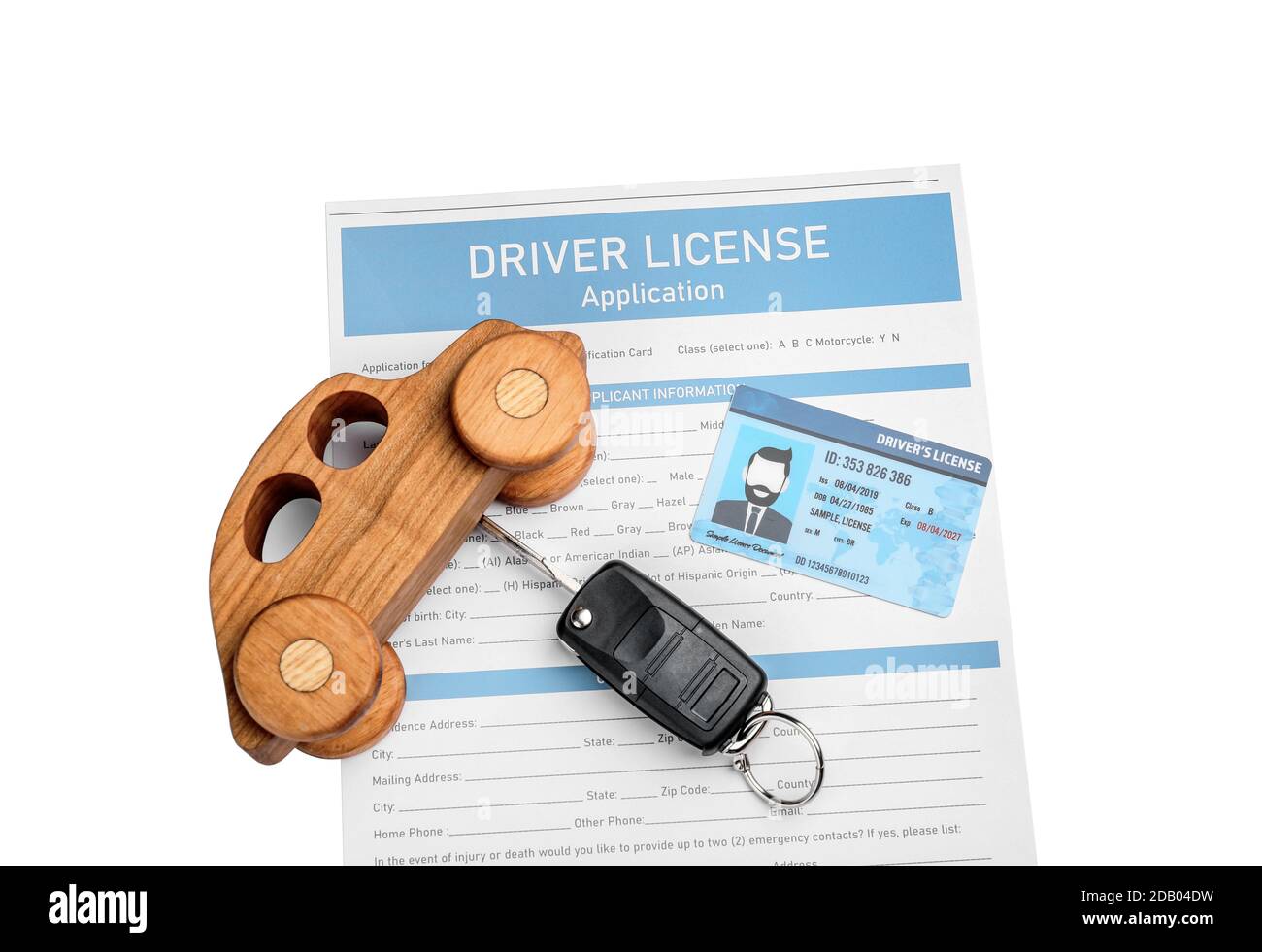 Driving license with car, key and application form on white background ...