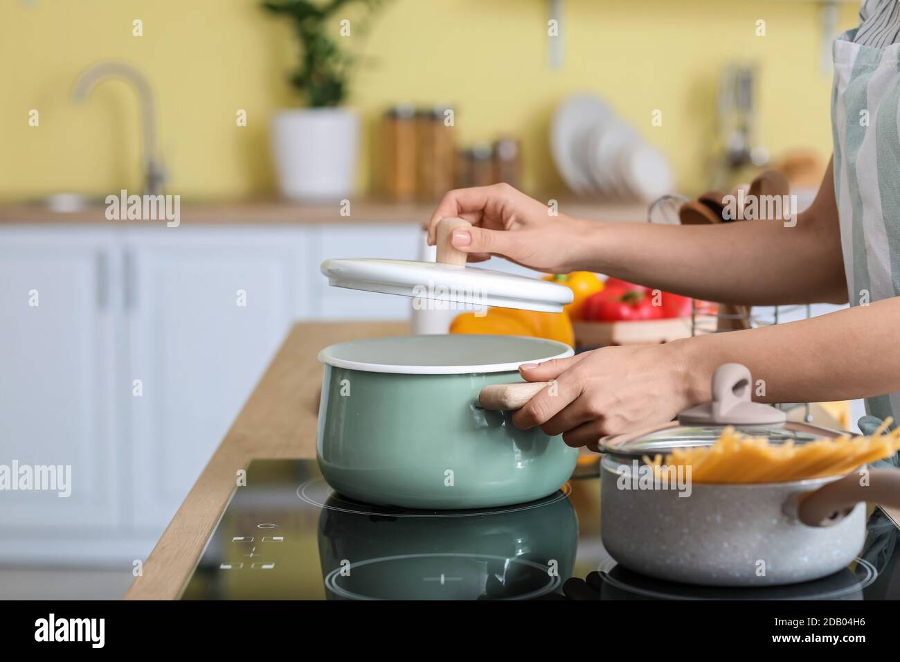 Woman cooking dinner in kitchen Stock Photo - Alamy