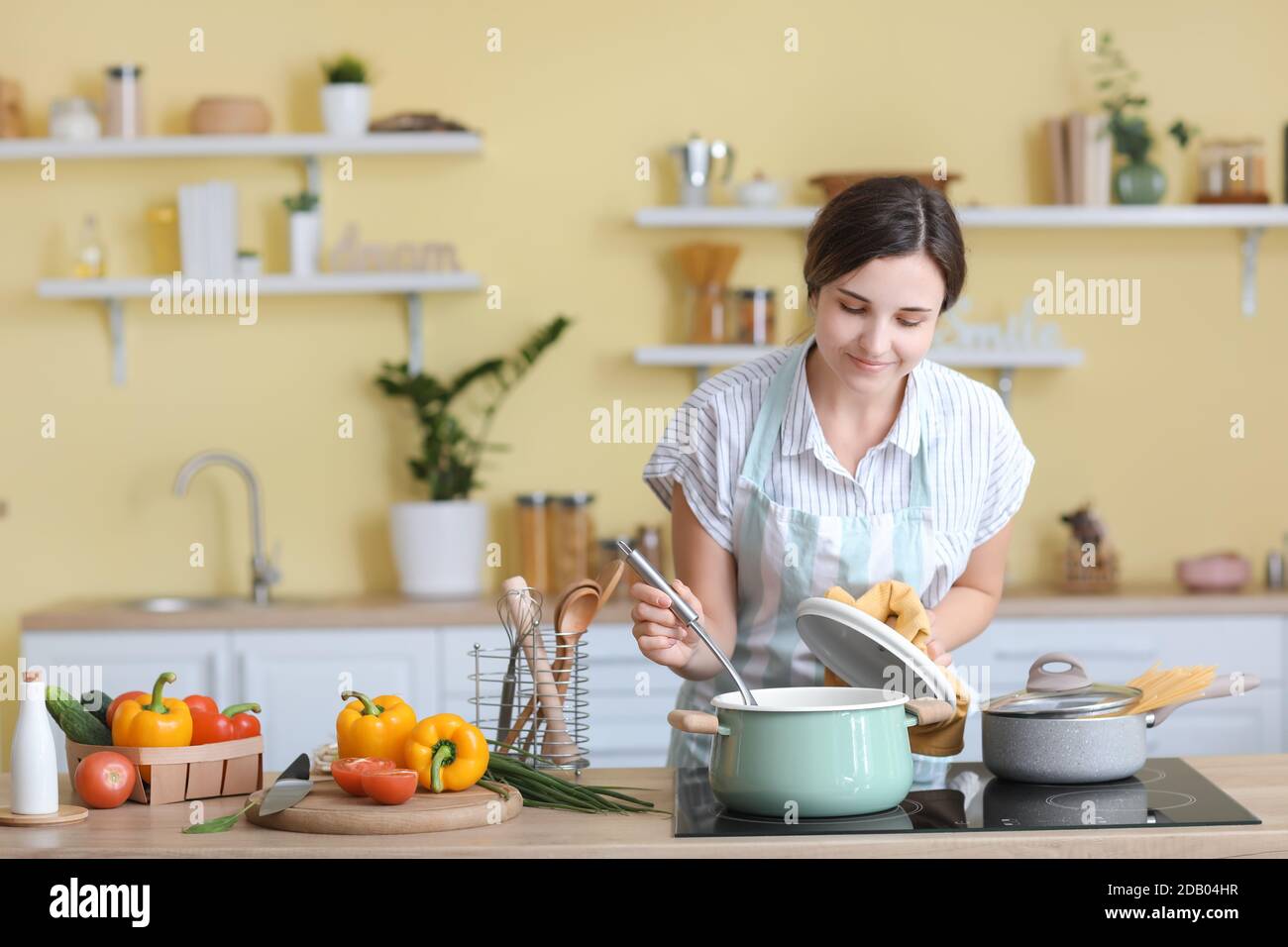 Woman cooking dinner in kitchen Stock Photo - Alamy