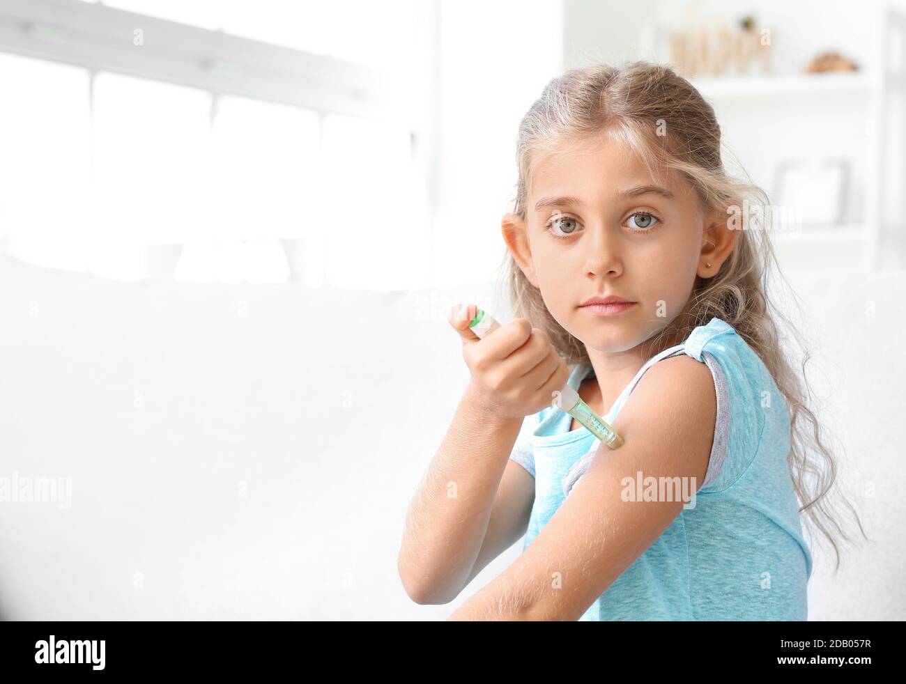 Little diabetic girl giving herself insulin injection at home Stock ...