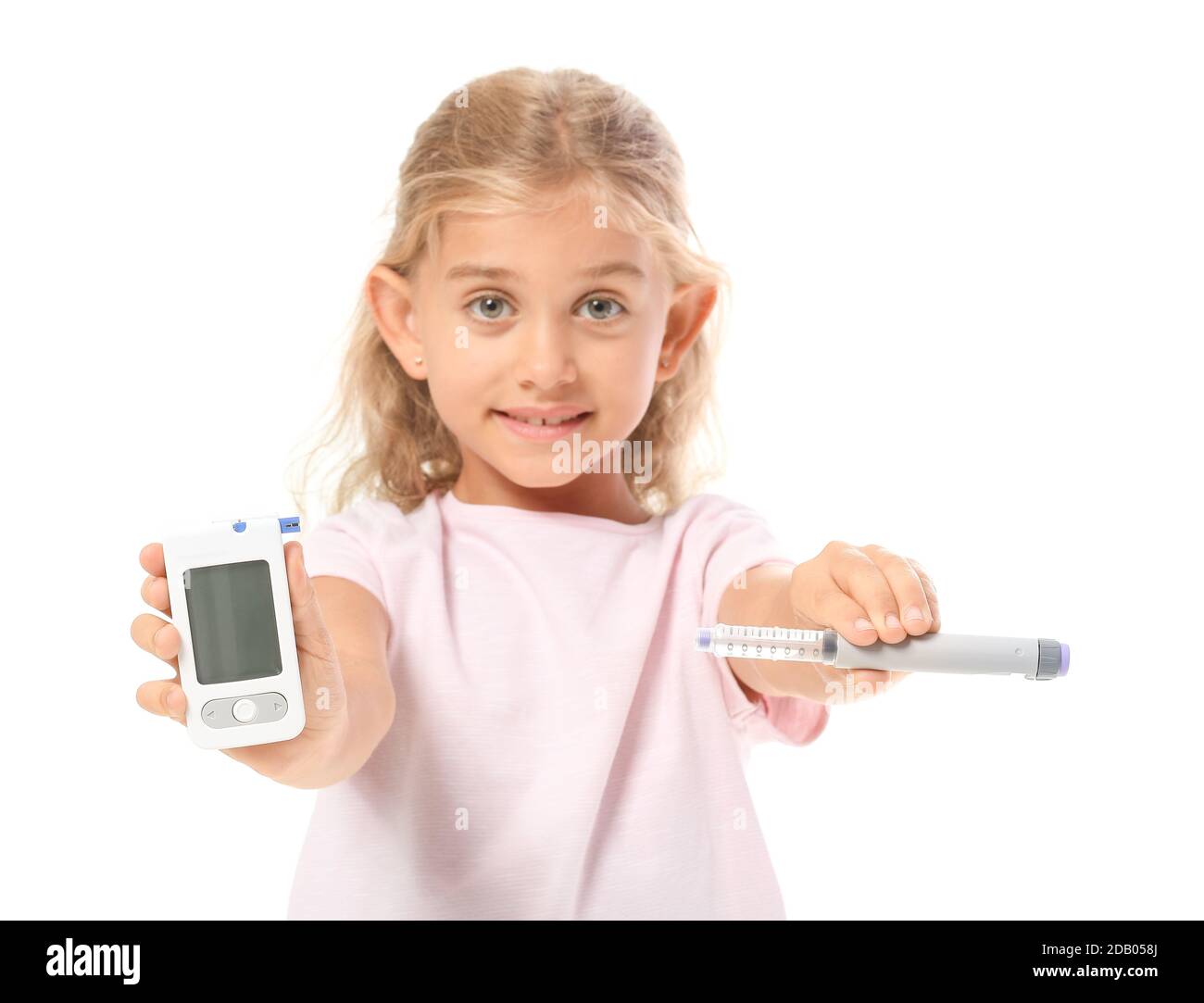 Little diabetic girl with insulin syringe and glucometer on white ...