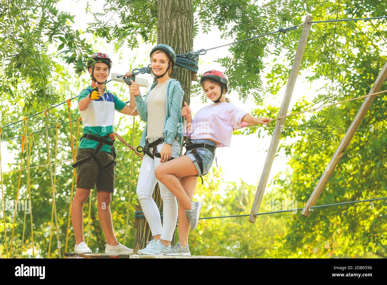 Teenagers climbing in adventure park Stock Photo - Alamy