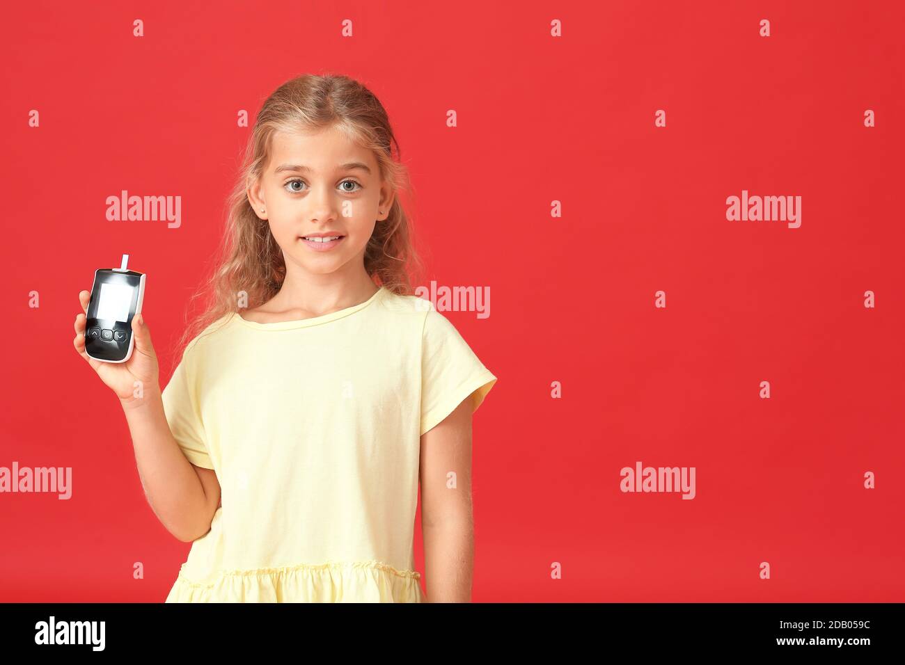 Little diabetic girl with glucometer on color background Stock Photo ...