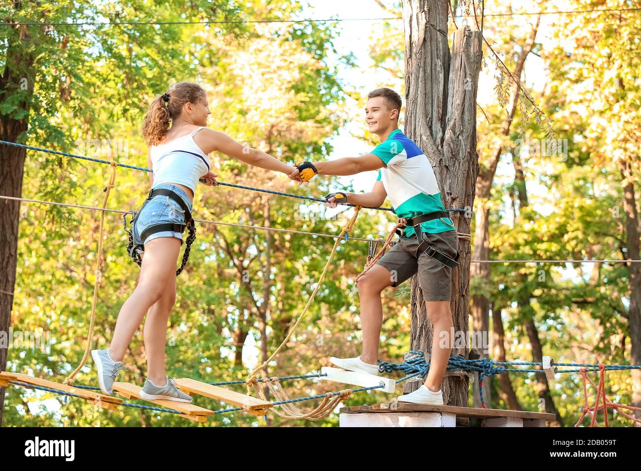 Teenagers climbing in adventure park Stock Photo - Alamy