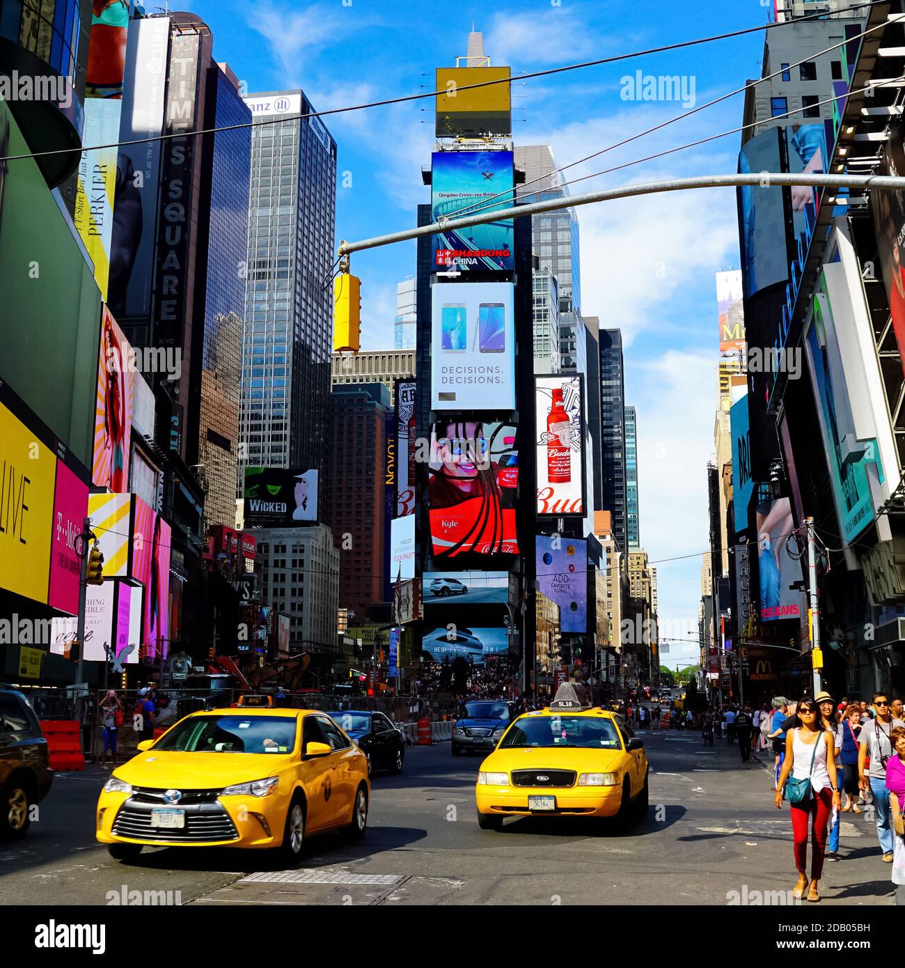 Times Square with yellow New York City Taxi cabs and tour buses driving ...