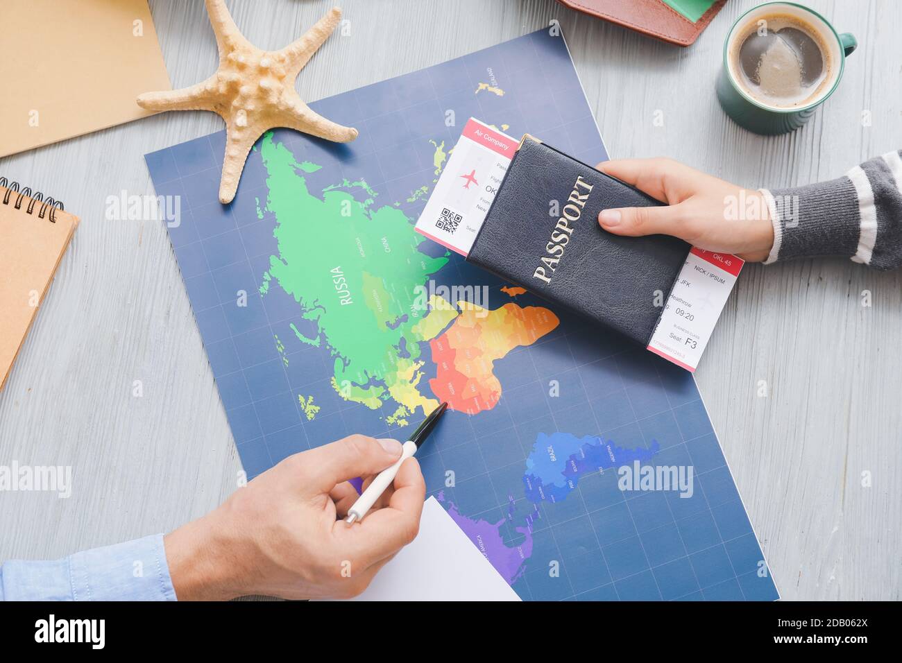 Travel agent choosing tour for client in office Stock Photo - Alamy
