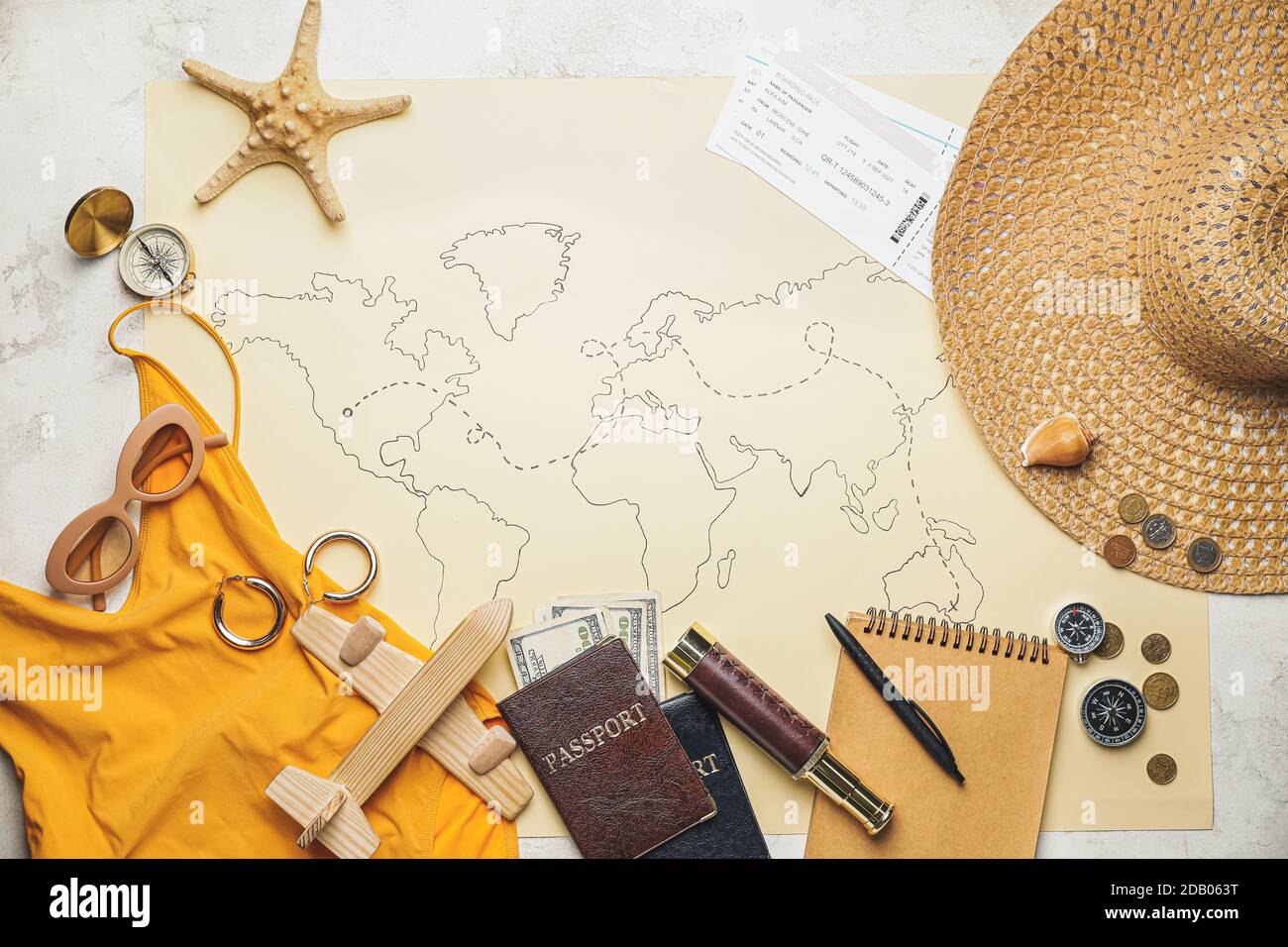 Set of travel items on world map Stock Photo - Alamy