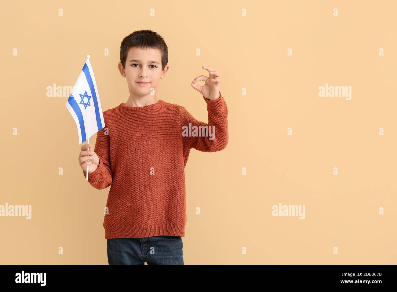Little boy with the flag of Israel showing OK on color background Stock ...