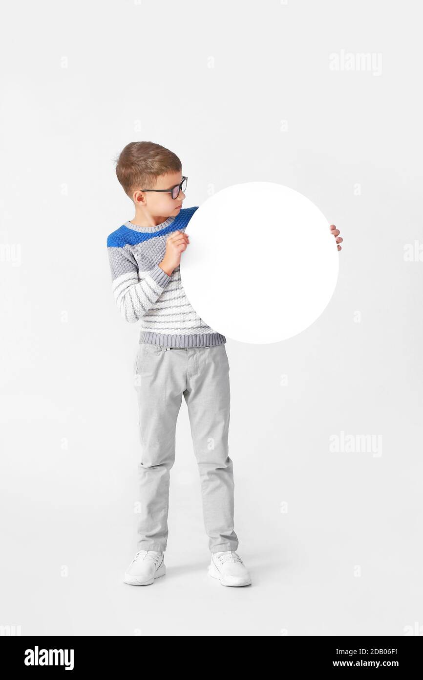 Little boy with blank paper sheet on light background Stock Photo - Alamy