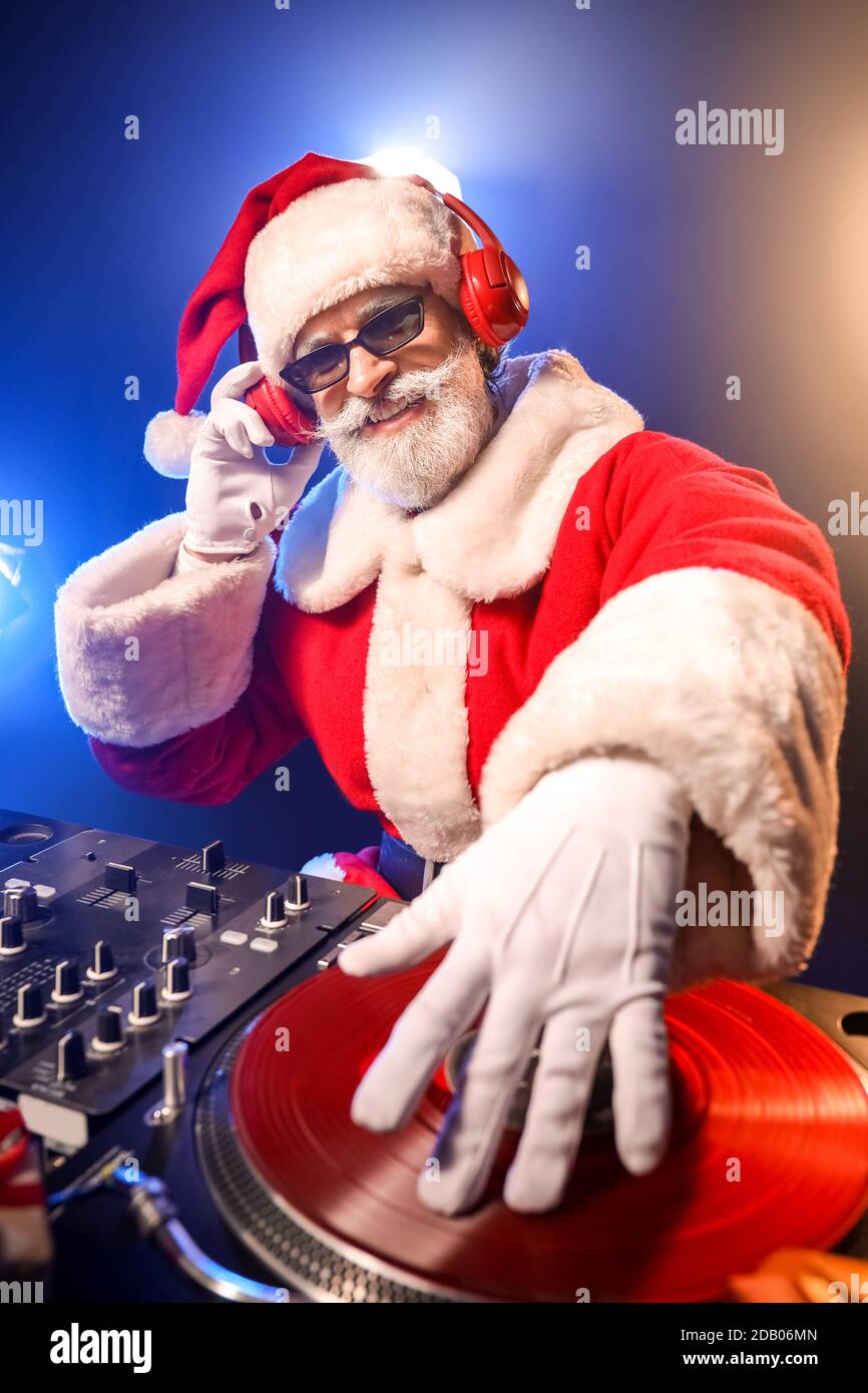 Cool Santa DJ playing music in club Stock Photo - Alamy