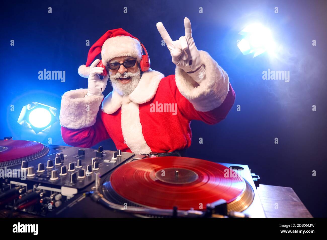 Cool Santa DJ playing music in club Stock Photo - Alamy