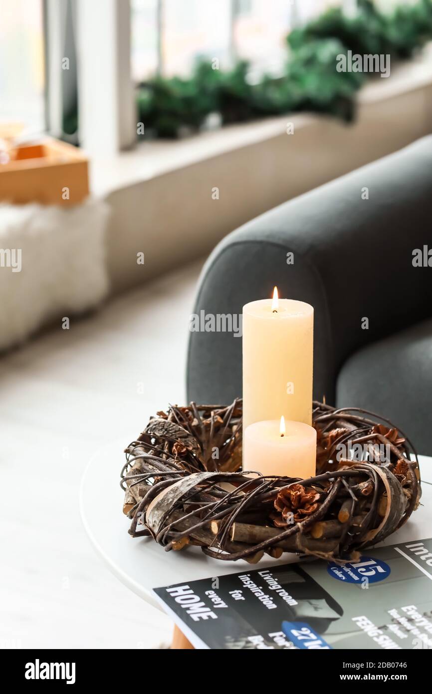 Burning candles and magazine on table in room Stock Photo - Alamy