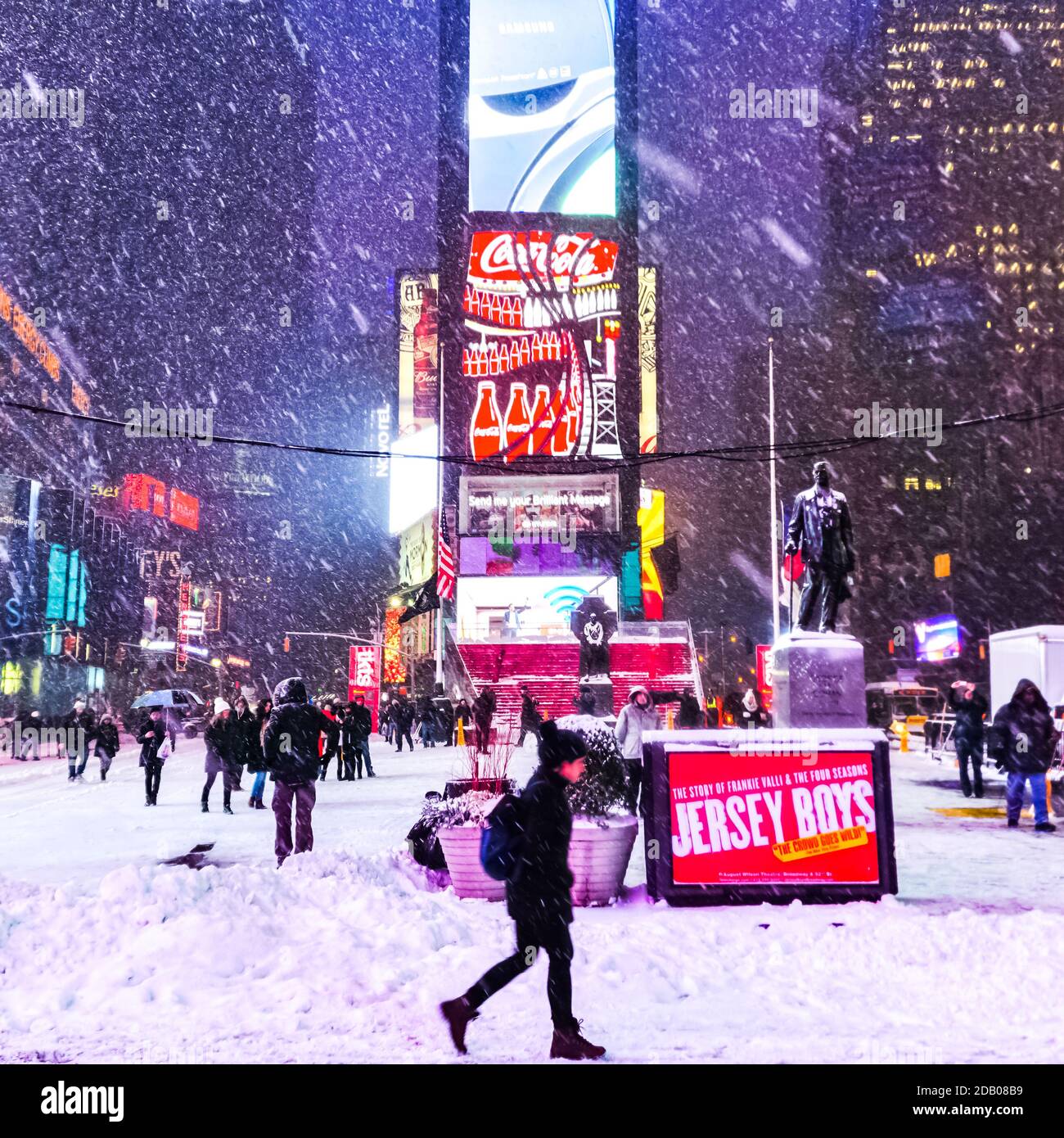 Times Square in winter blizzard snowstorm with people commuting and ...