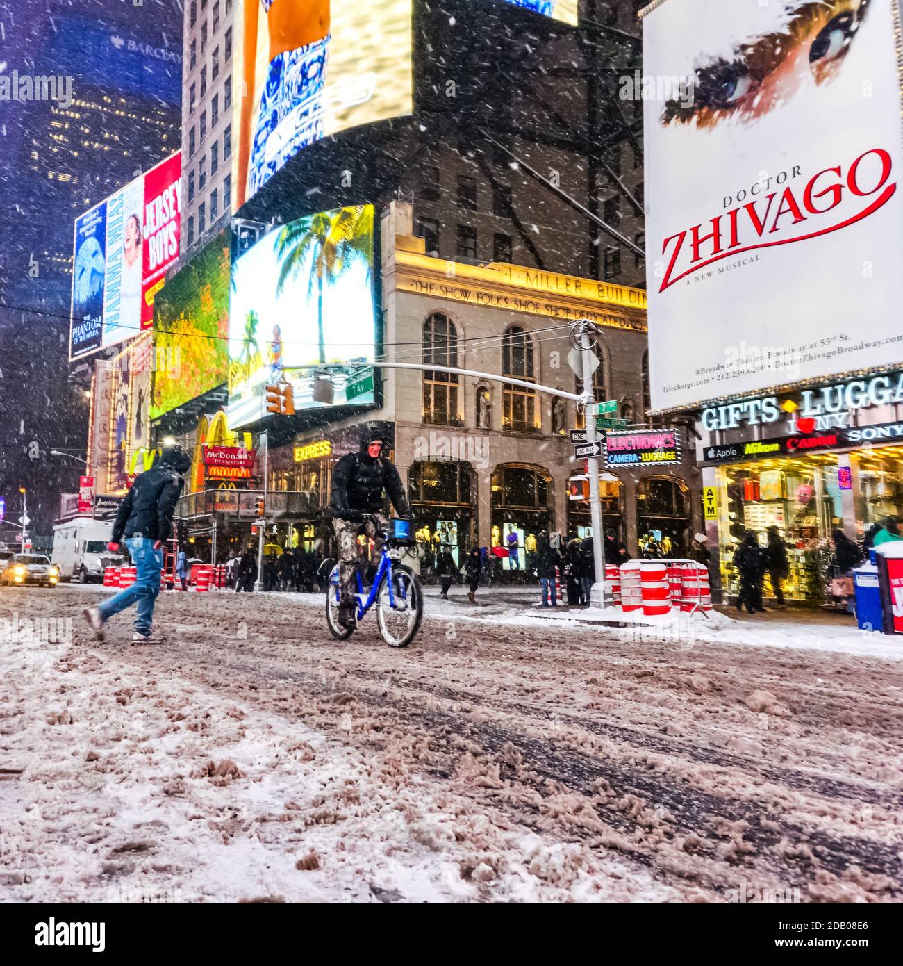 Times Square in winter blizzard snowstorm with people commuting and ...