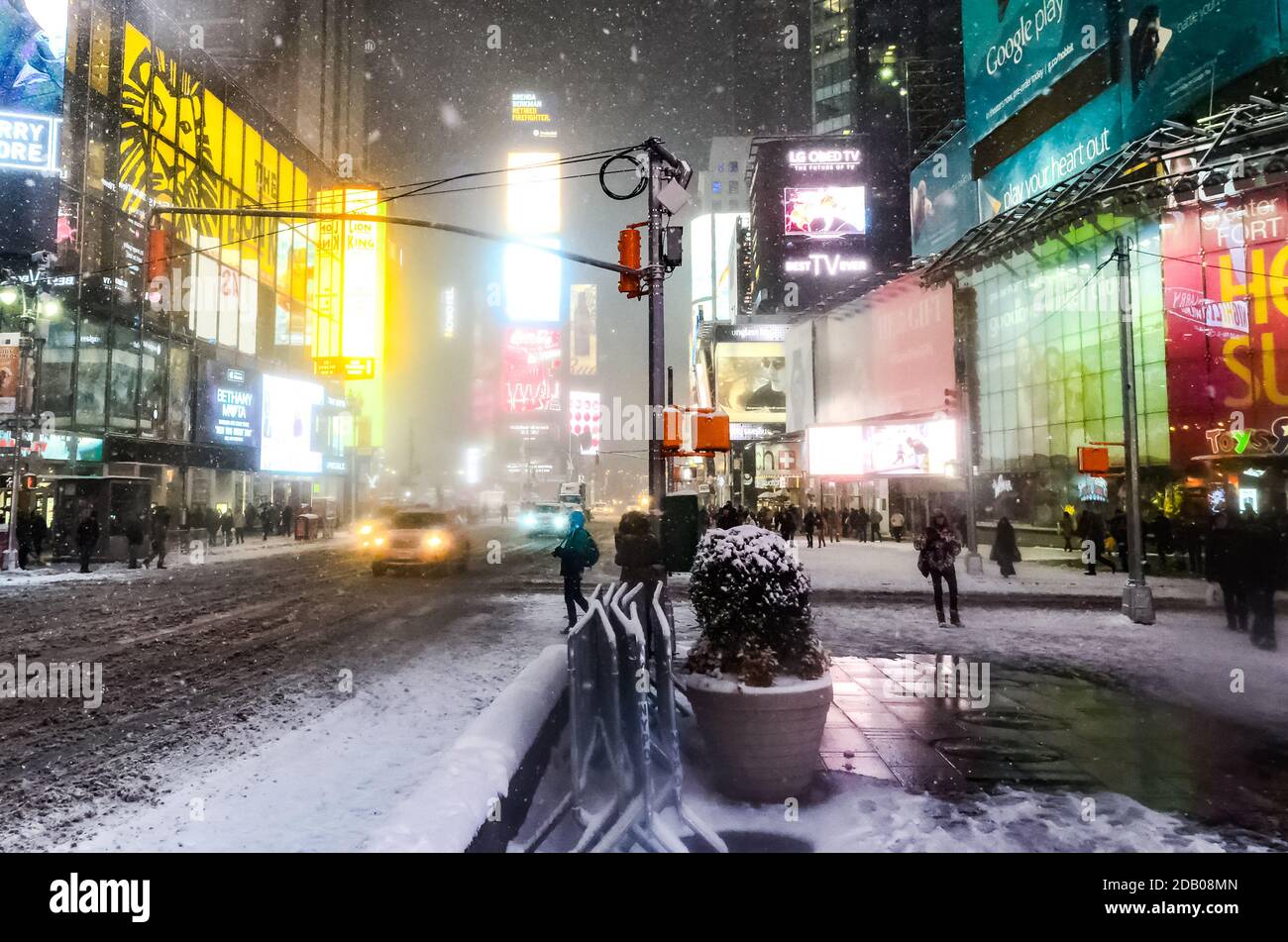 Times Square in winter blizzard snowstorm with people commuting and ...