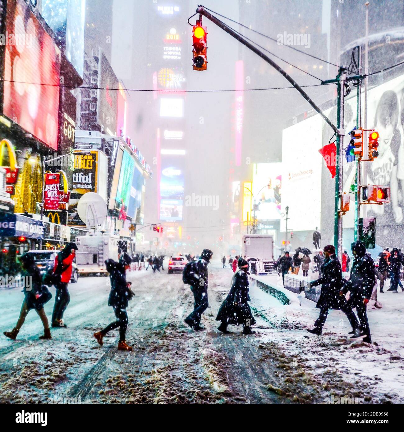 Times Square in winter blizzard snowstorm with people commuting and ...