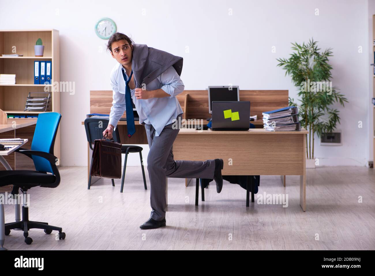 Male employee being late for his job Stock Photo - Alamy