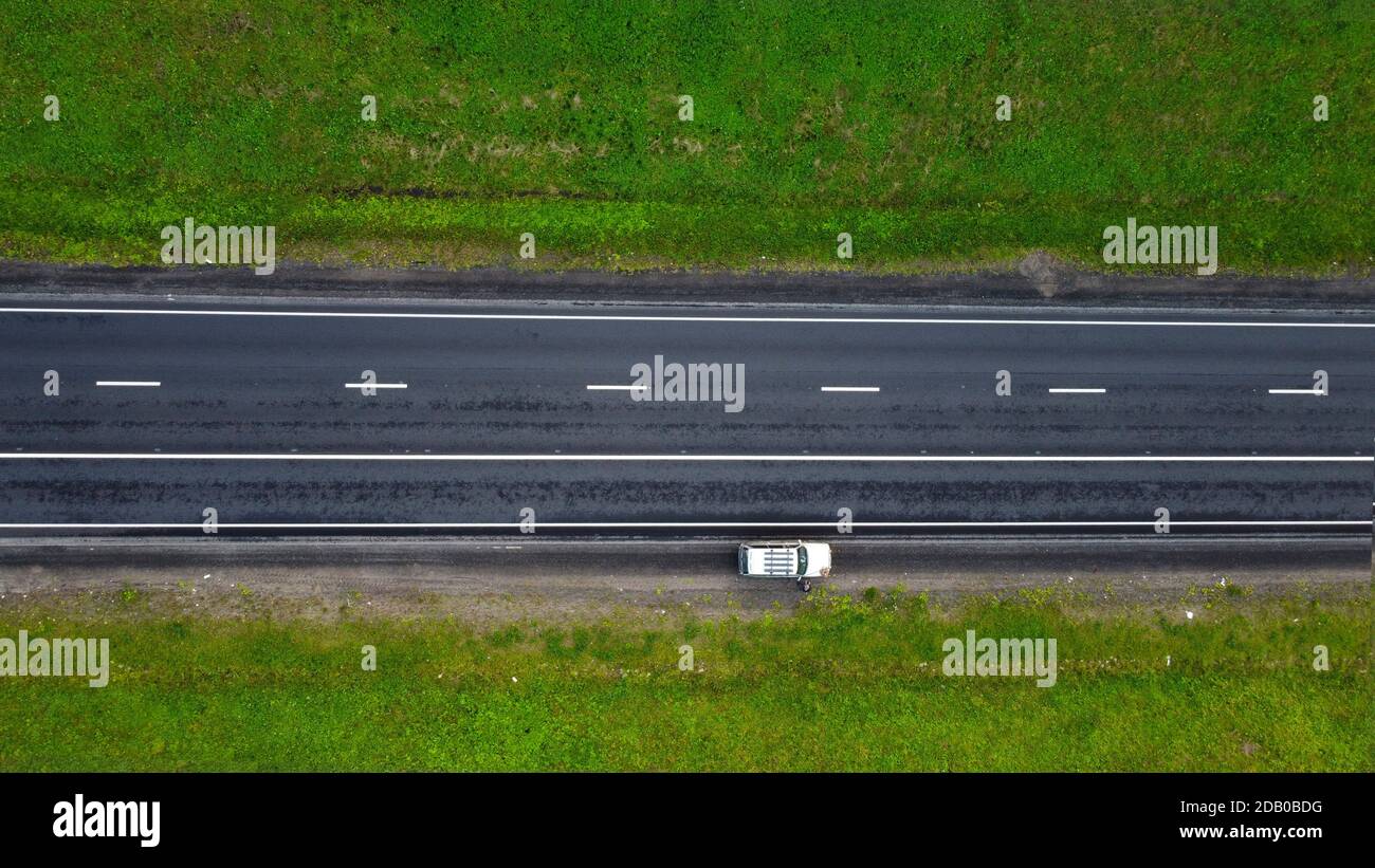 top view. part of the highway in spring. along the green fields. on a ...