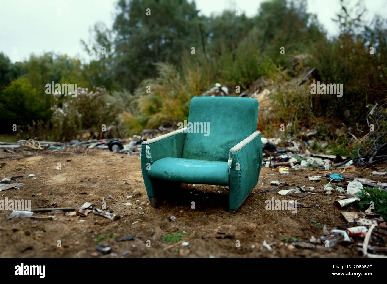 The old chair is in a landfill. Abandoned wasteland with waste and ...
