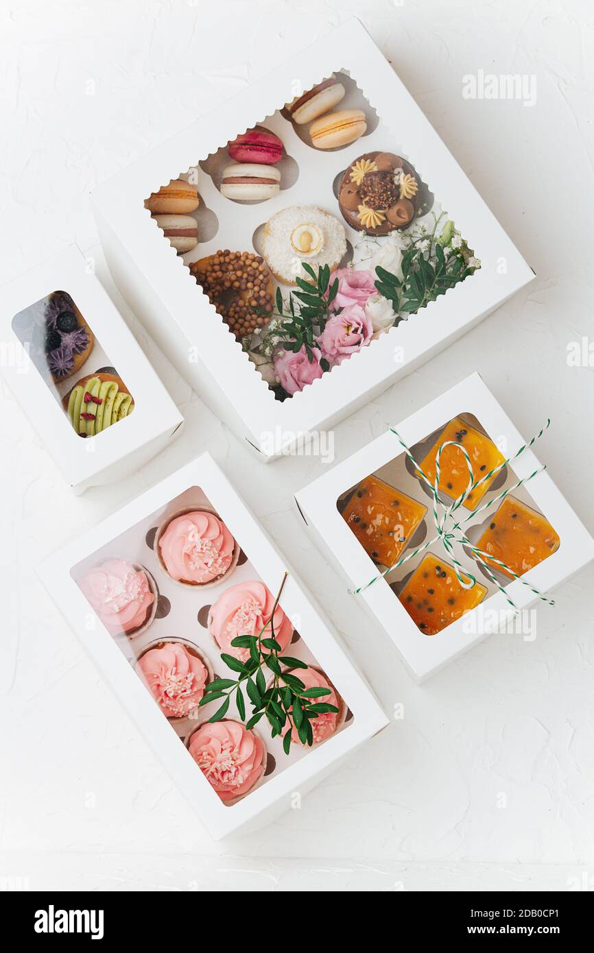 Vibrant colorful sweets in white windowed boxes. Top view Stock Photo ...
