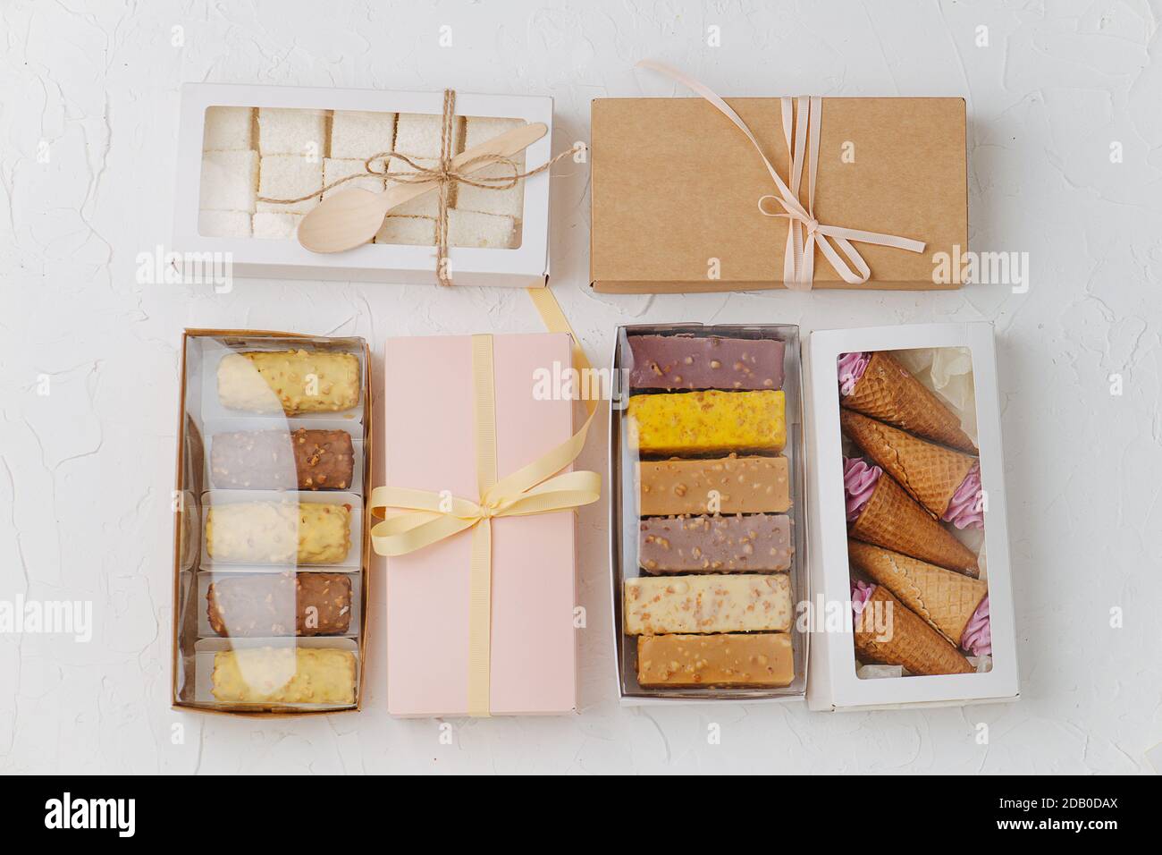 Variety of sweets in windowed and sealed boxes. Top view. On white ...