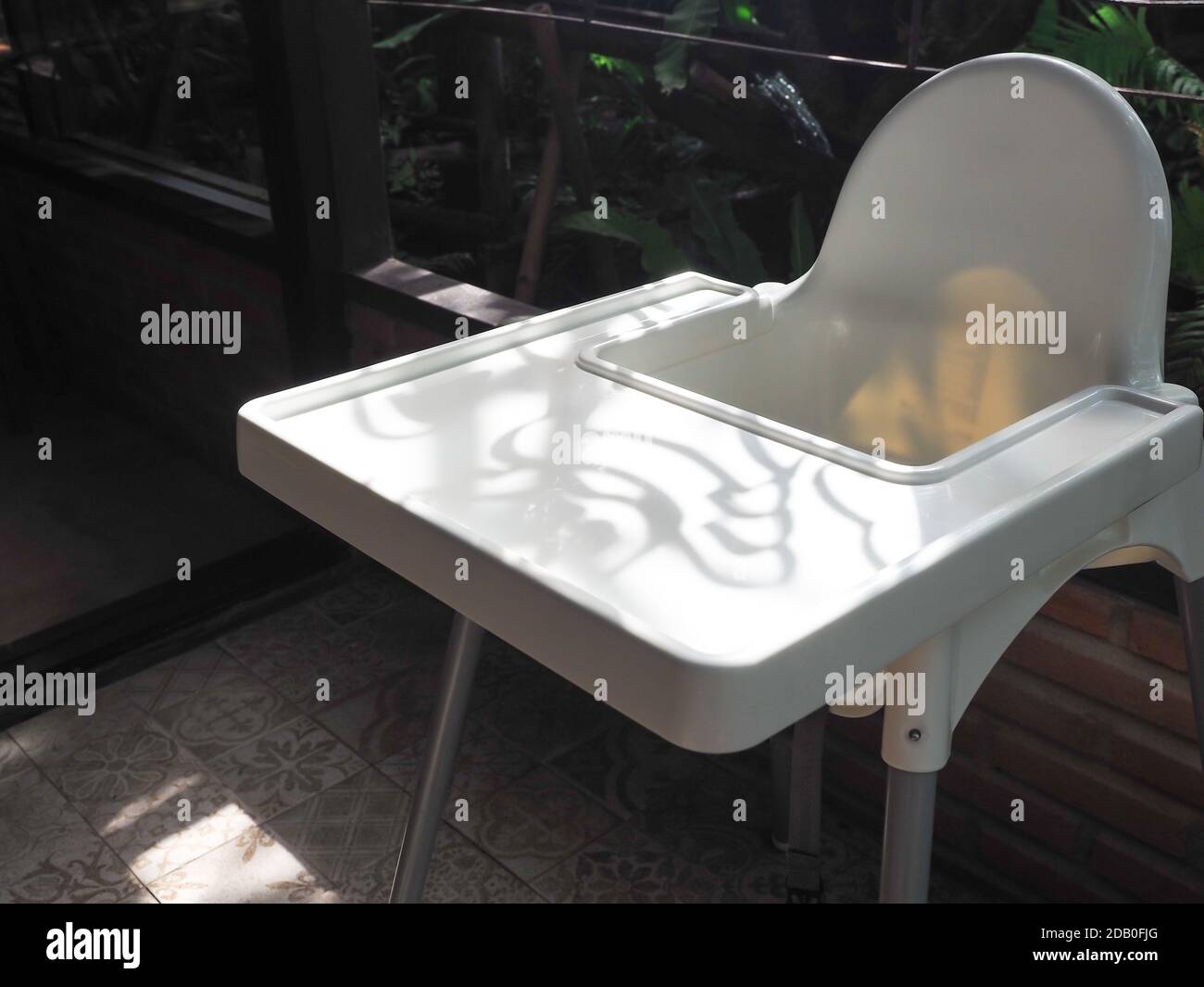 Empty lonely old white dining chair for children in dark garden Stock ...