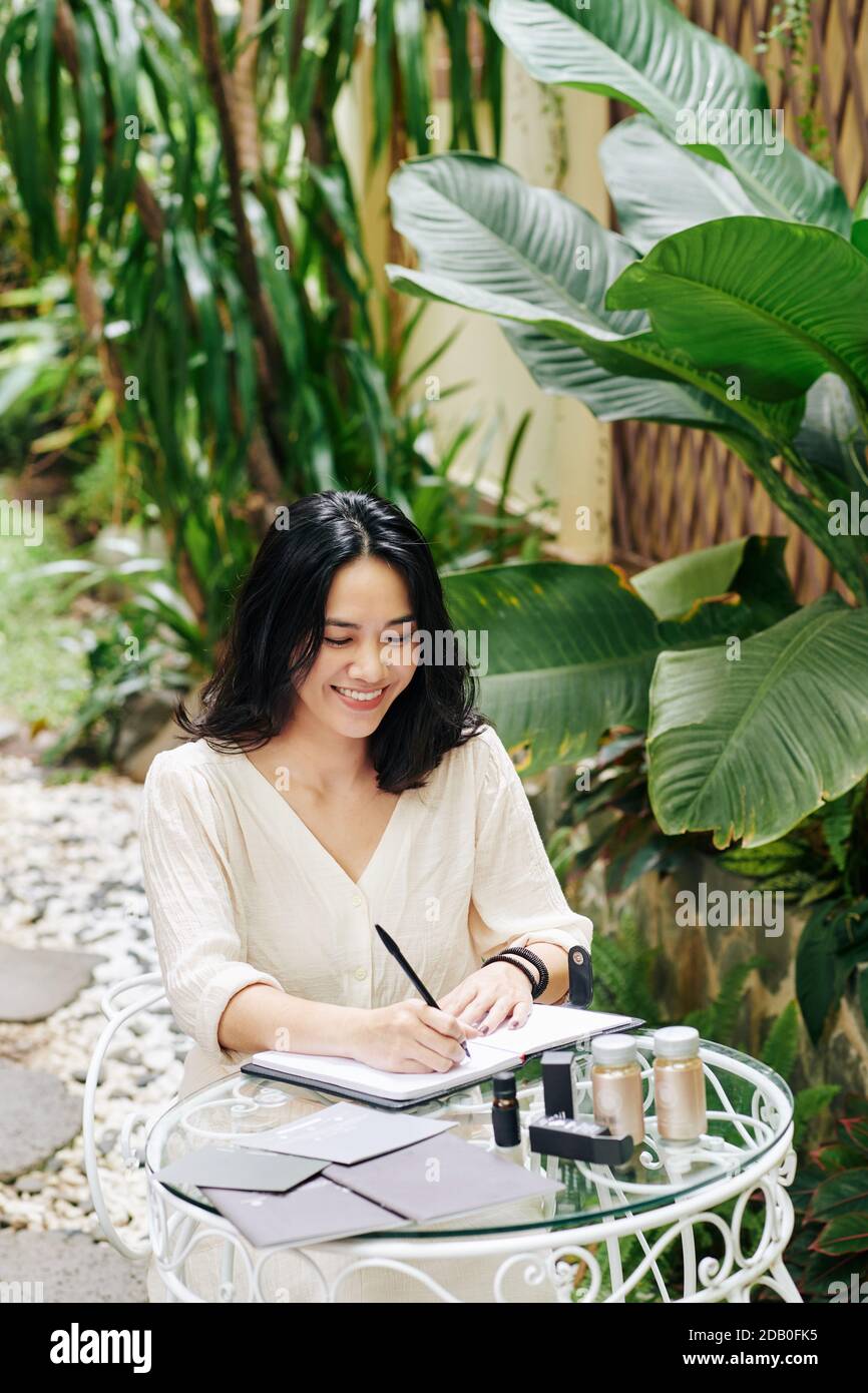 Woman writing business plan Stock Photo - Alamy