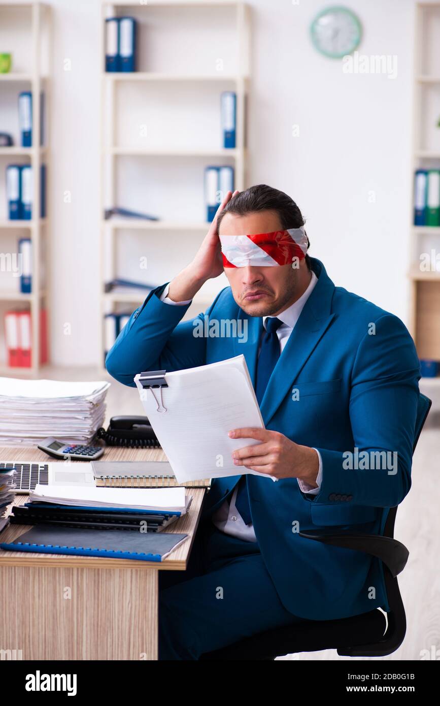 Blindfolded employee working in the office Stock Photo - Alamy