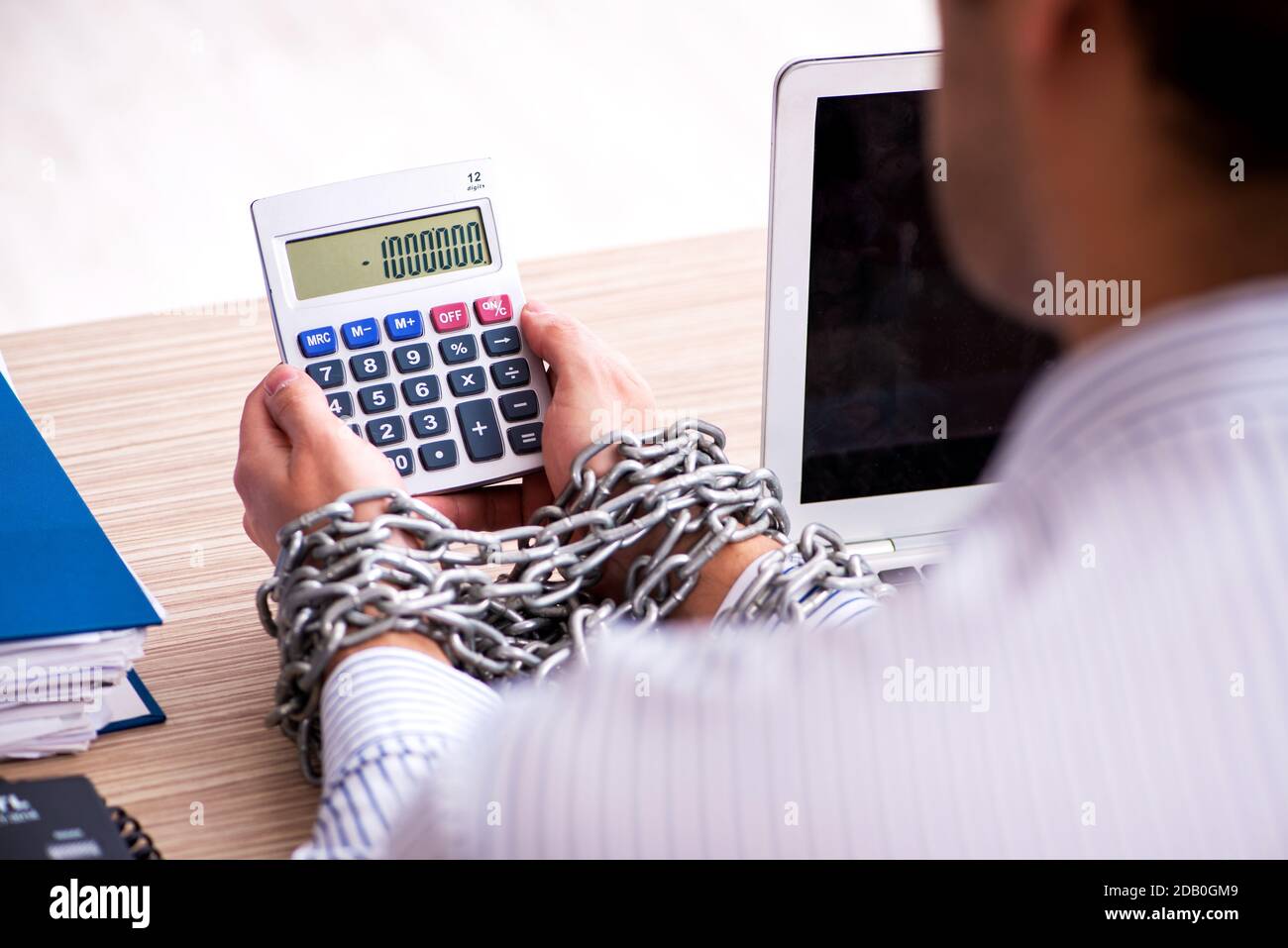 Chained employee working in the office Stock Photo - Alamy