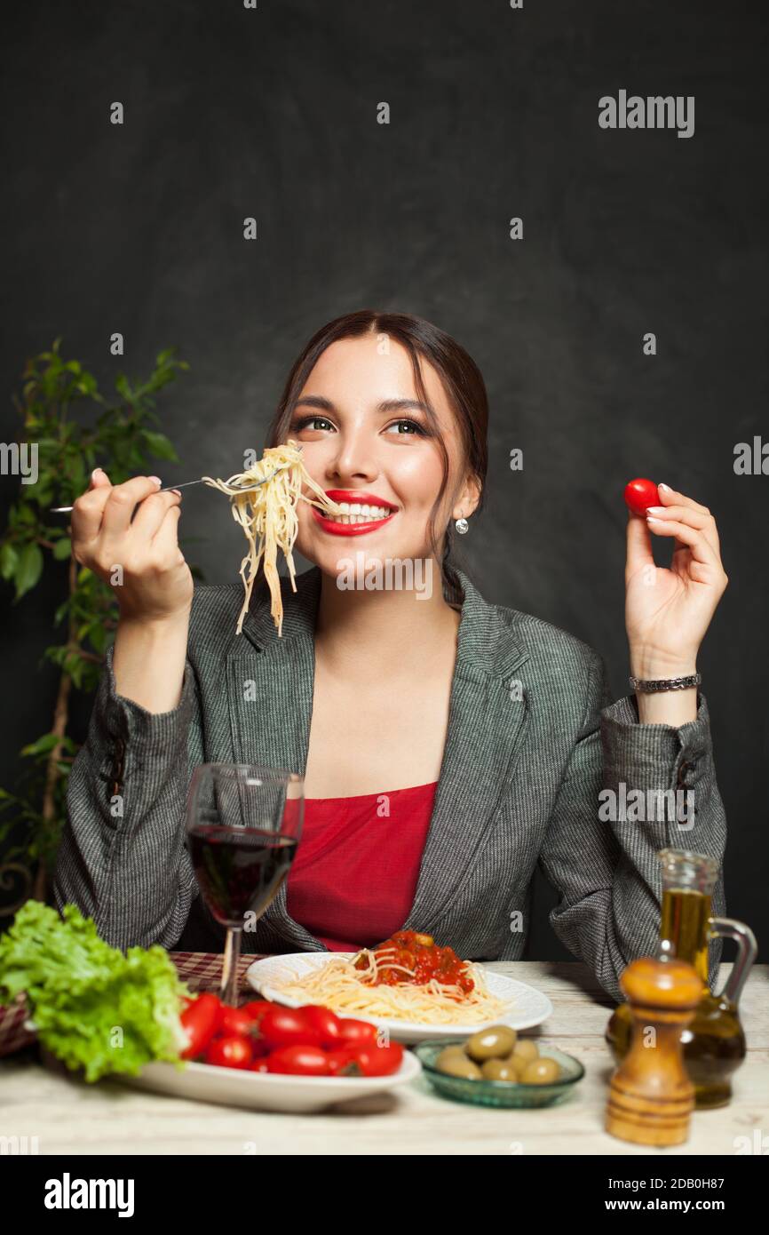 Happy nice woman eating italian pasta in restaurant Stock Photo - Alamy