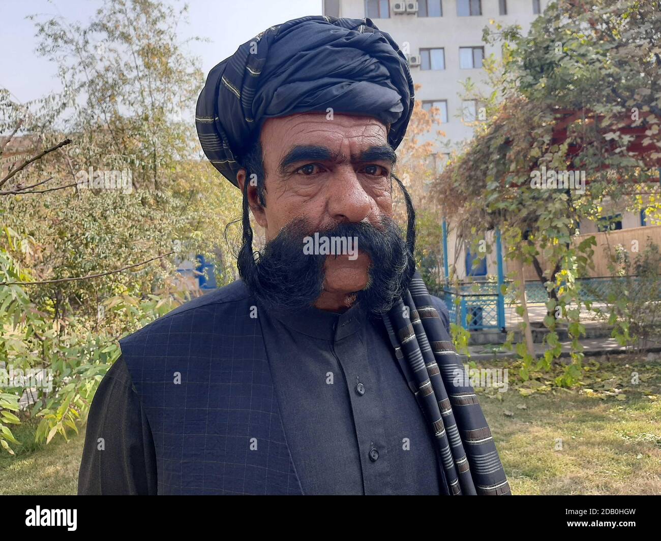 Kabul, Afghanistan. 13th Nov, 2020. The Afghan tailor Shere Khan shows ...