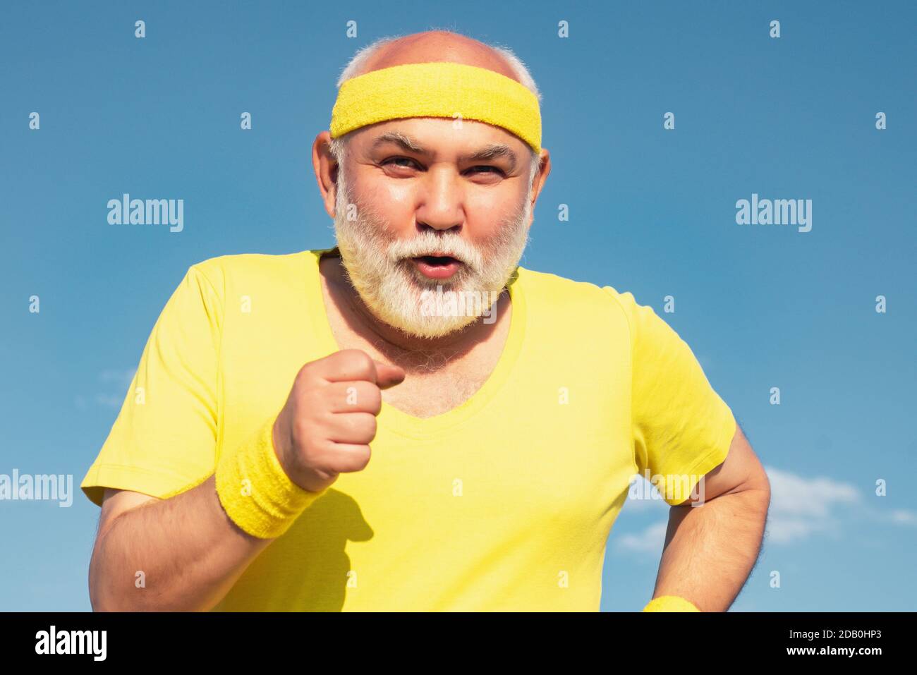 Senior male is enjoying sporty lifestyle. Senior sportsman jogging ...
