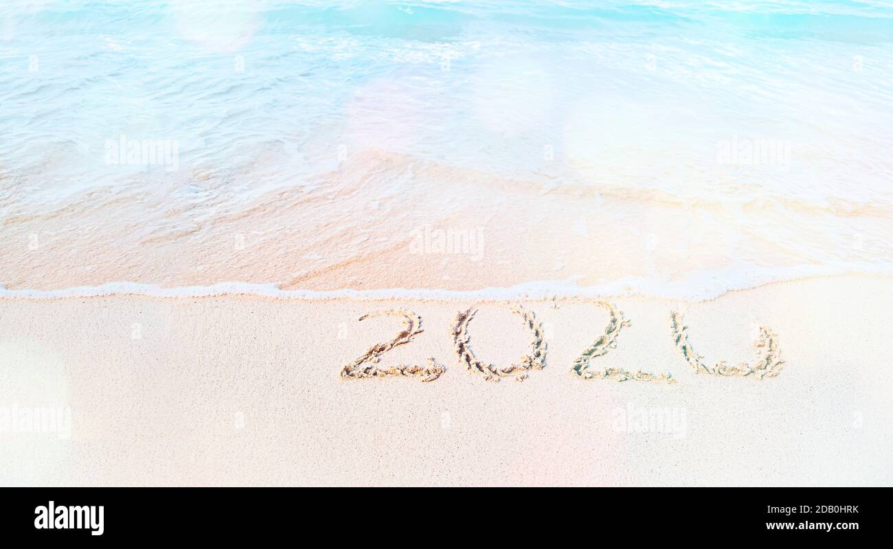 Year 2020 Written At The Sandy tropical Beach with coming sea waves ...
