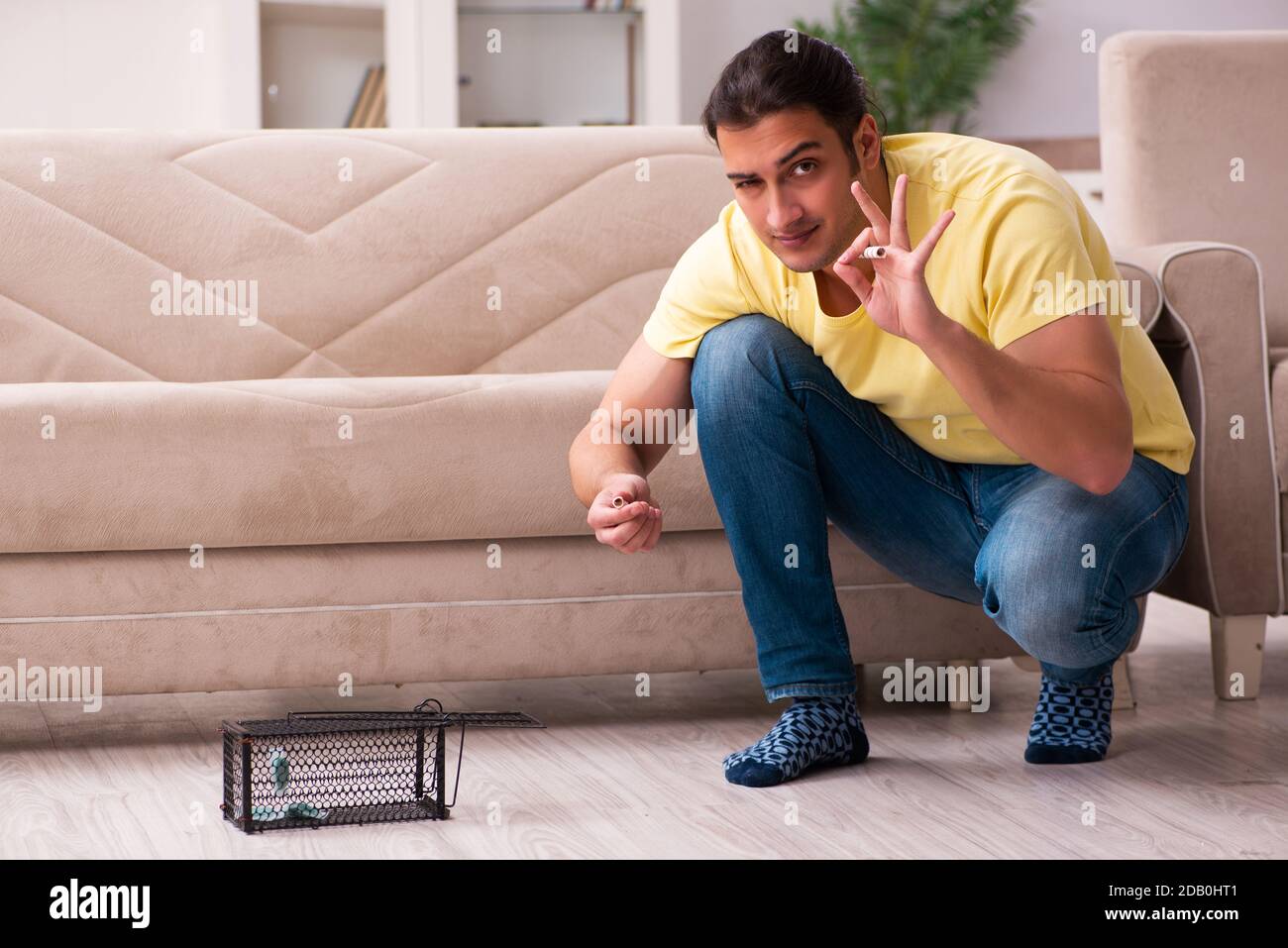 Man and mousetrap at home Stock Photo - Alamy
