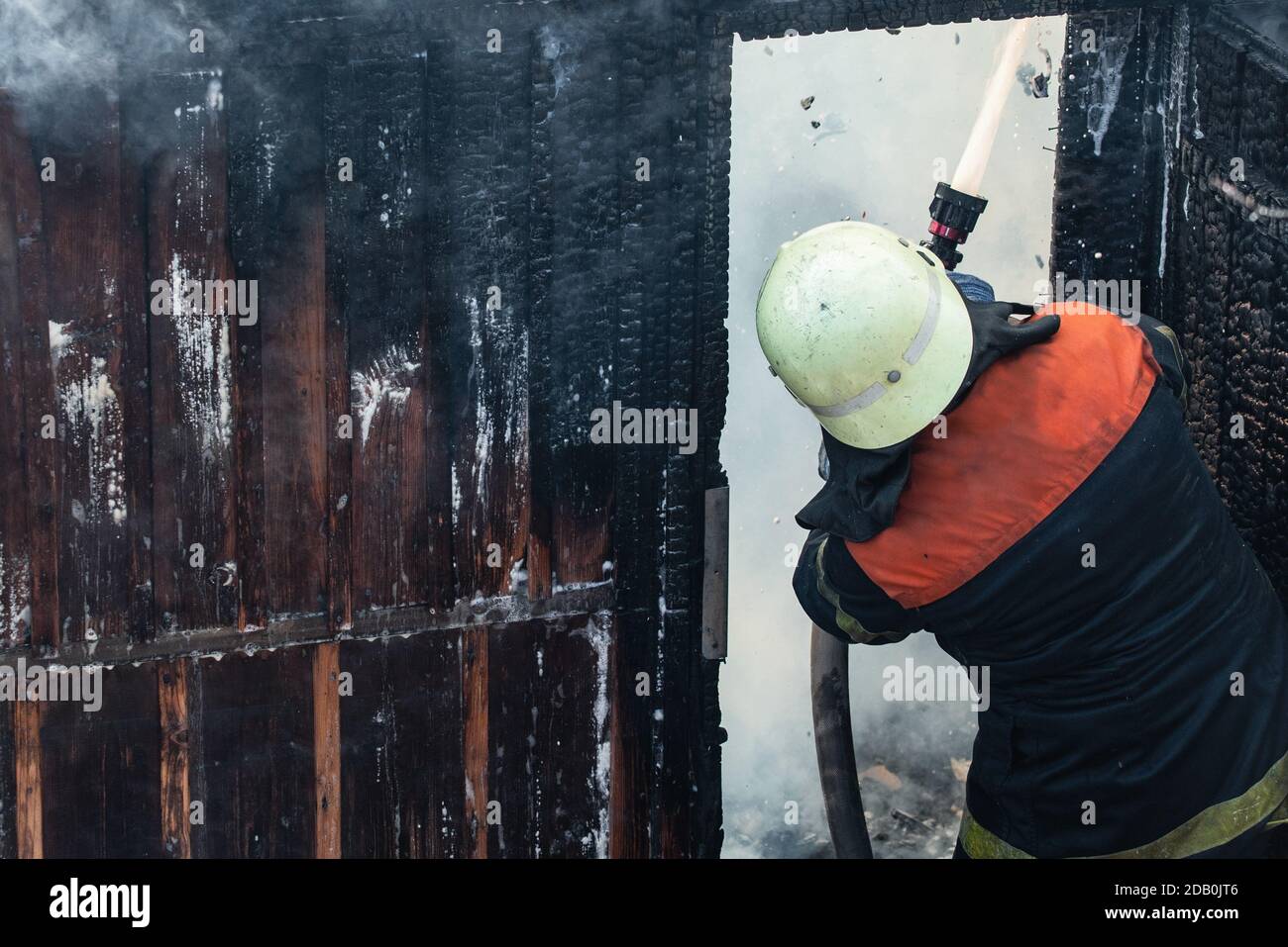 Firefighter work concept. Firefighter are using water in fire fighting ...