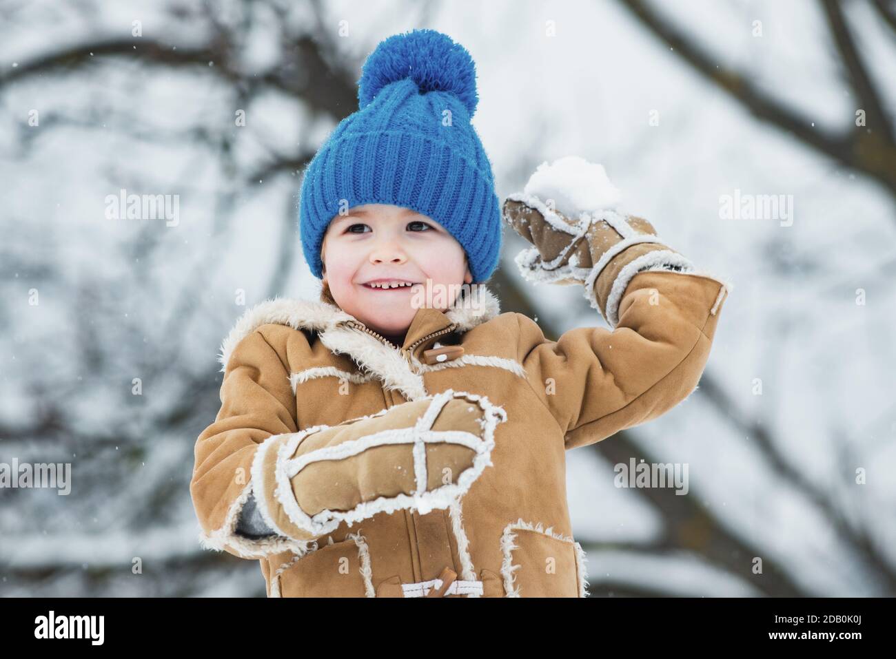 Making snowball and winter fun for children. Enjoying nature wintertime ...