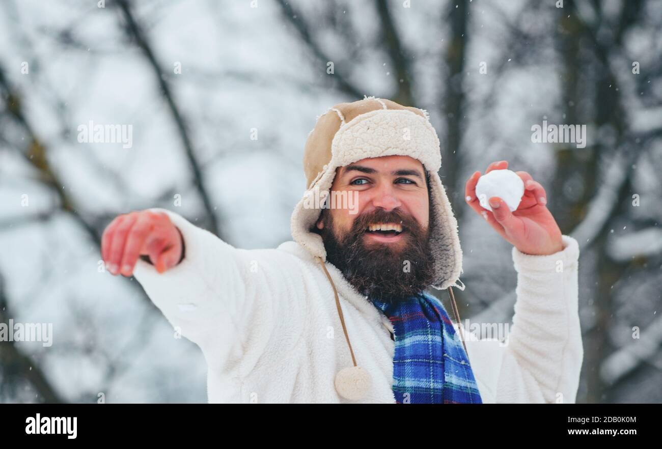 Christmas preparation - man with snowball. Winter scene on white snow ...