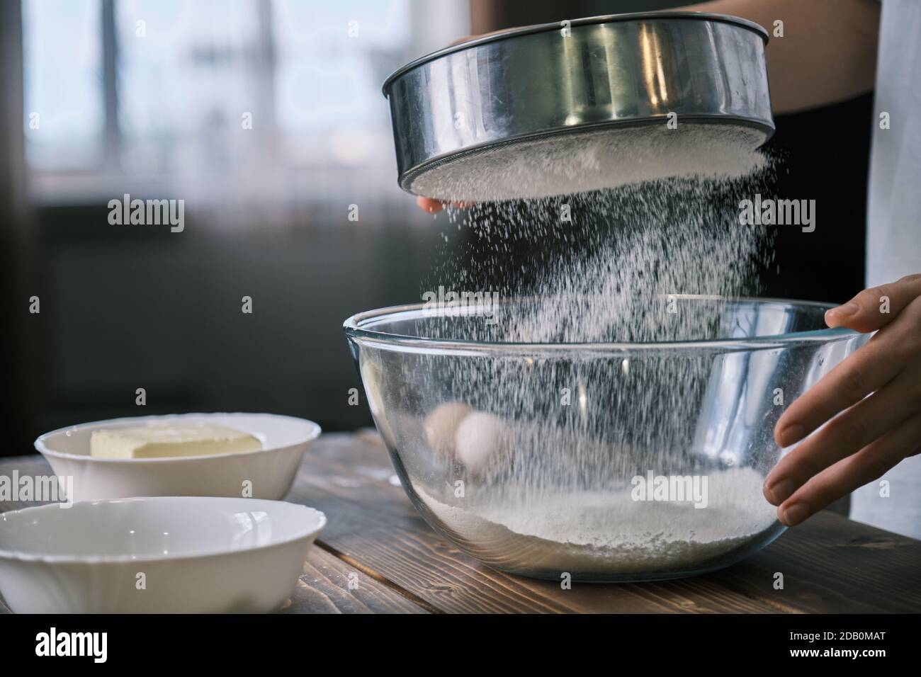 Female hands Sift flour in a glass bowl Stock Photo - Alamy