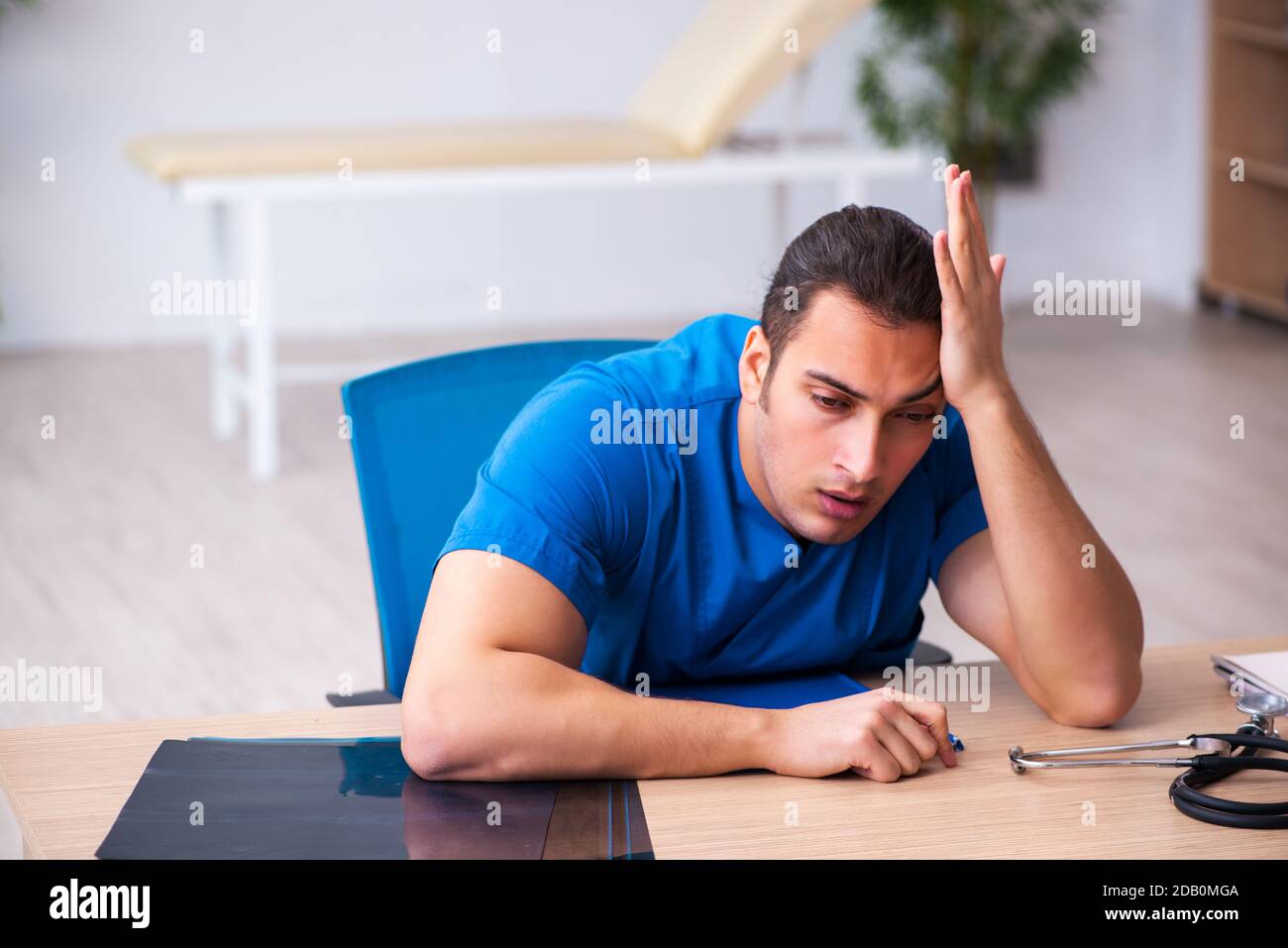 Young doctor being extremely tired after night shift Stock Photo - Alamy