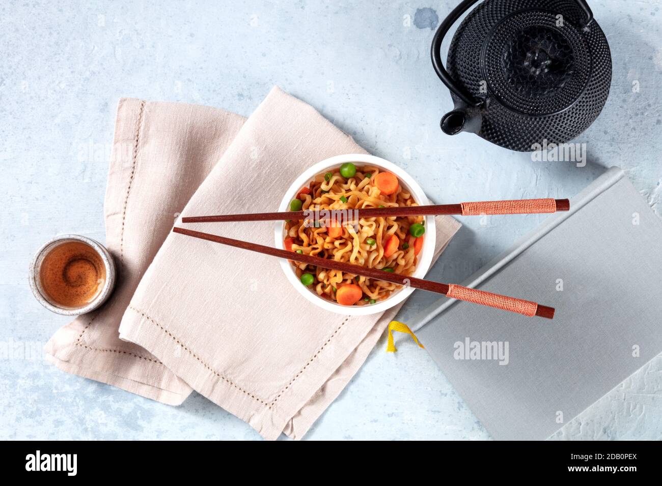 Ramen cup. Instant noodles in a plastic cup, shot from the top with tea ...