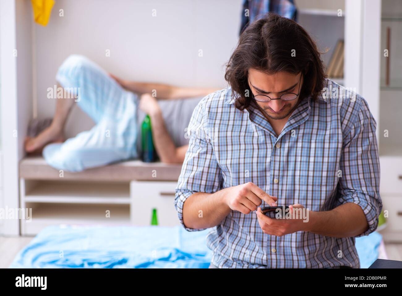 Young son student and dad alcoholic at home Stock Photo - Alamy