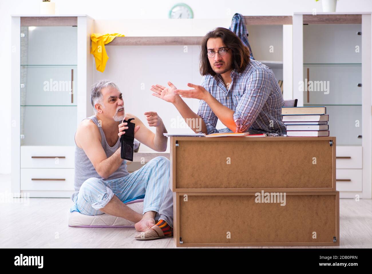 Young son student and dad alcoholic at home Stock Photo - Alamy