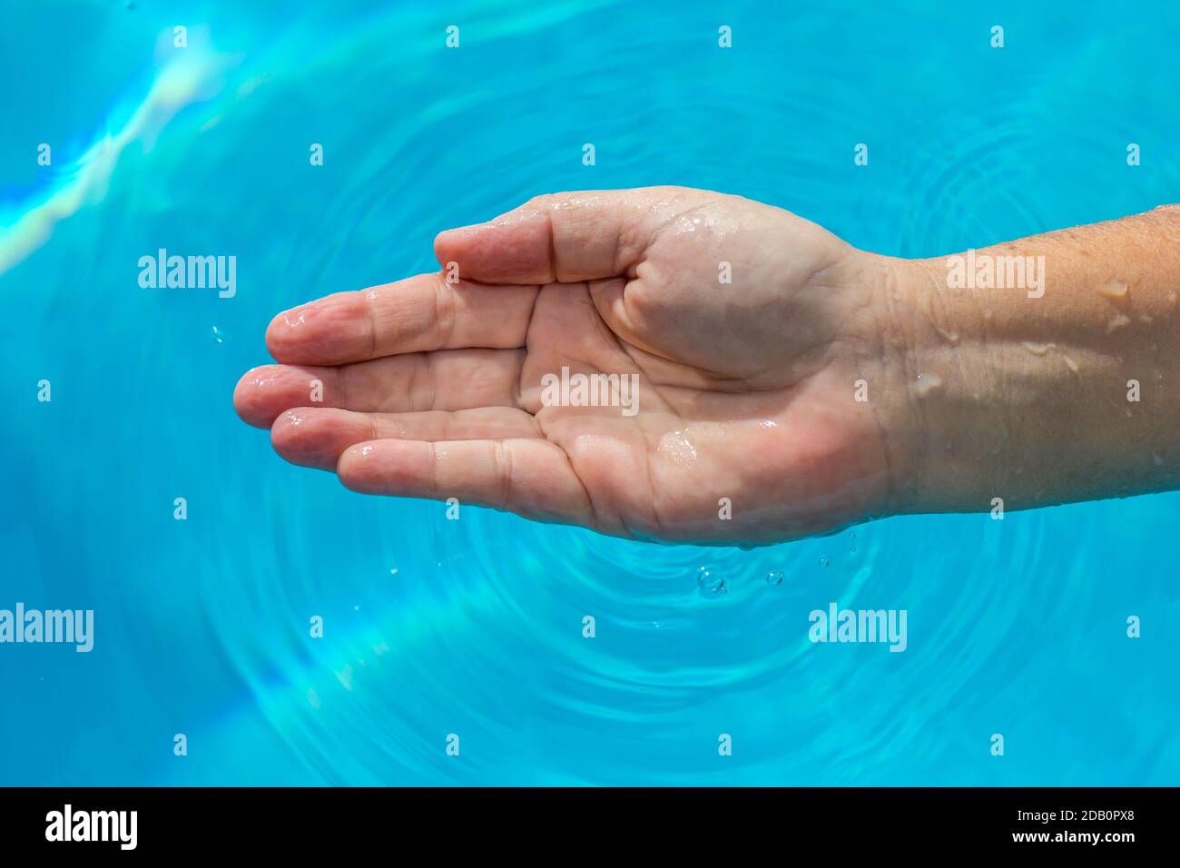 Shot of a wet hand on a water background Stock Photo - Alamy