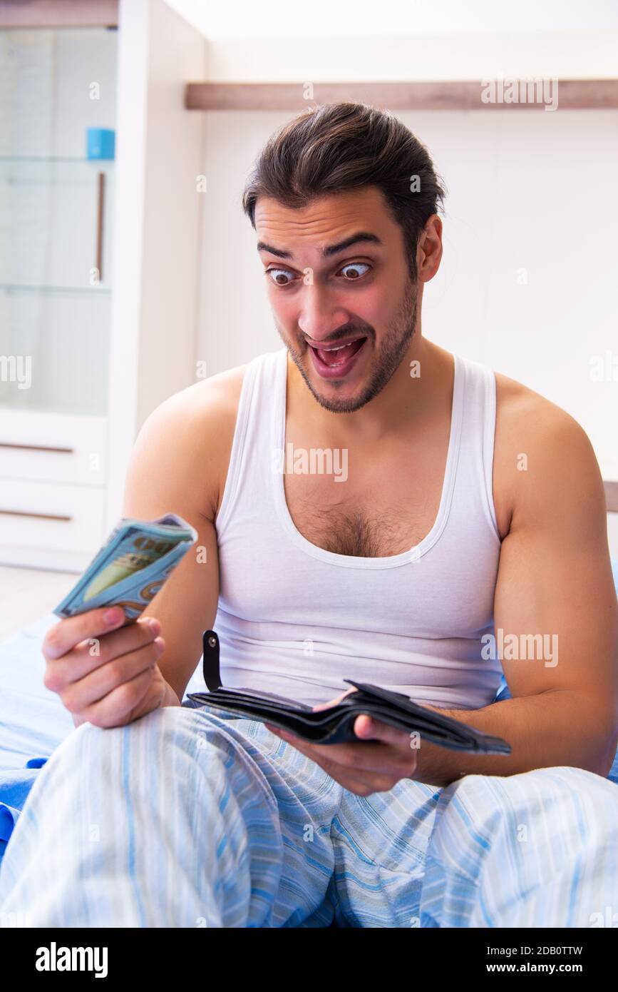 Young man in insolvency concept Stock Photo - Alamy