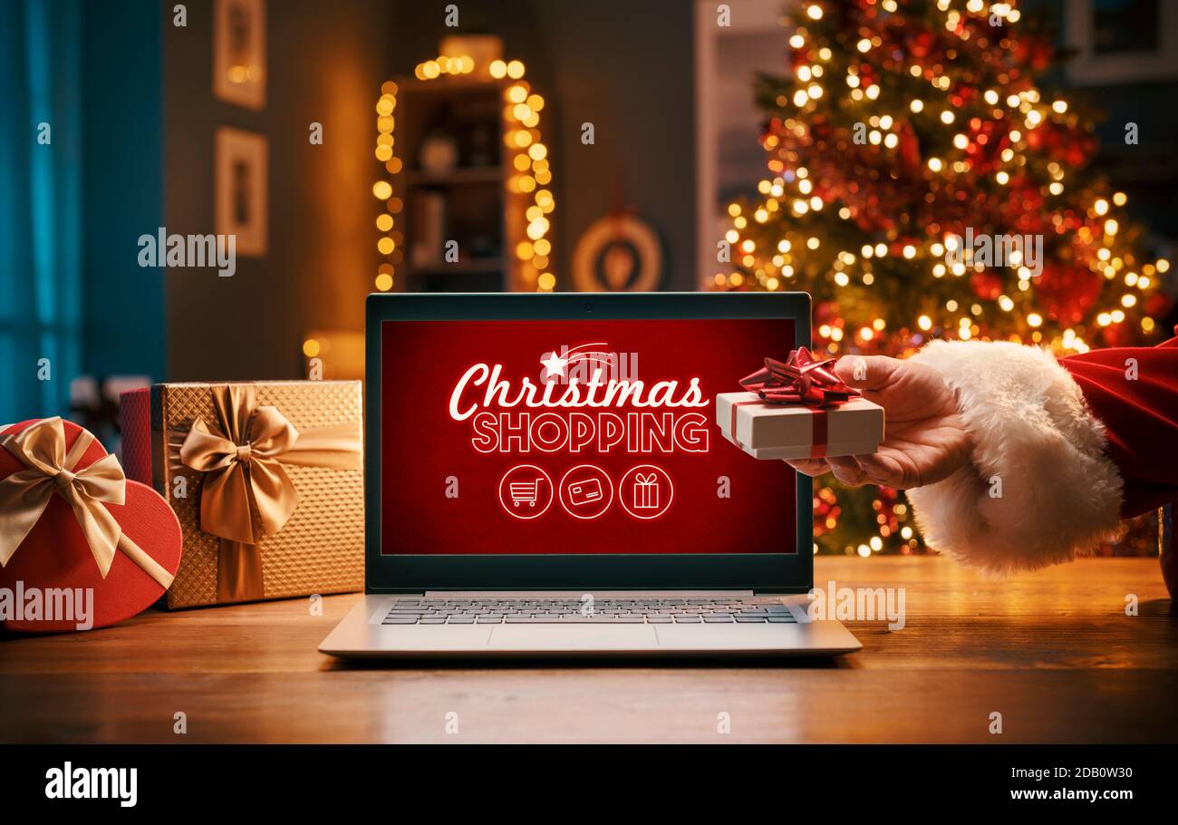 Santa Claus bringing a gift at home and Christmas shopping ...