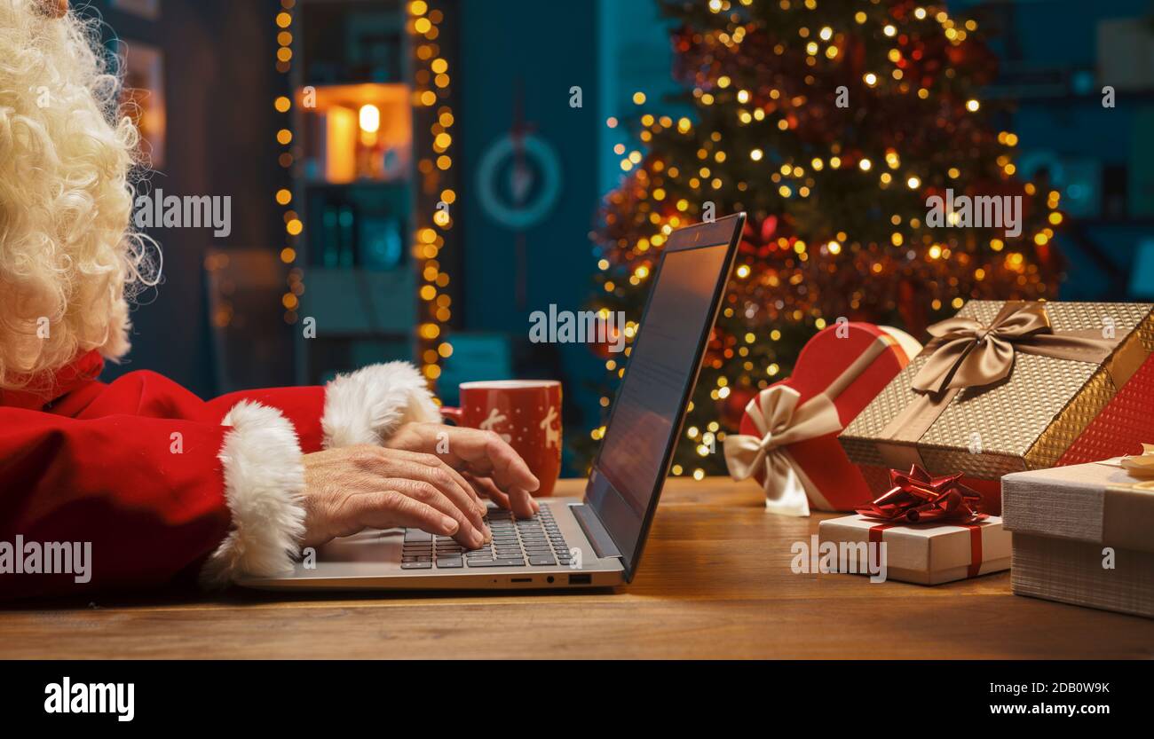 Santa Claus connecting online and social networking at Christmas, he is ...